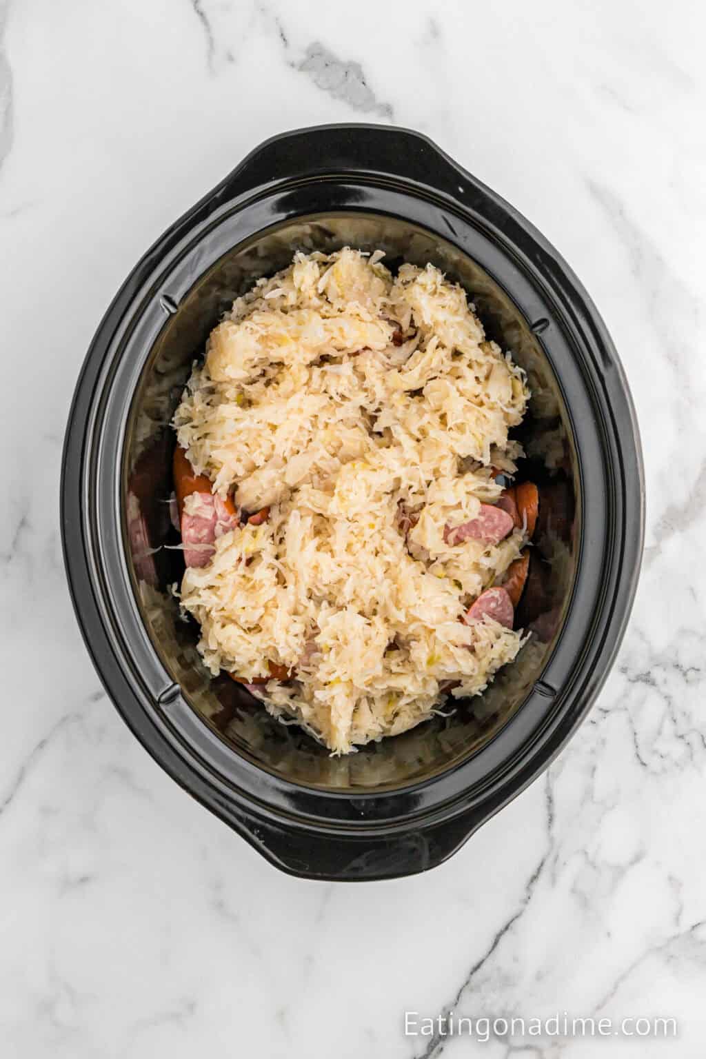 Slow Cooker Kielbasa and Sauerkraut Made Easy - Eating on a Dime